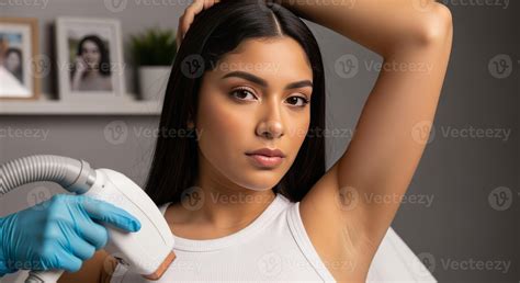Woman Receiving Underarm Hair Removal Treatment With Laser In Studio