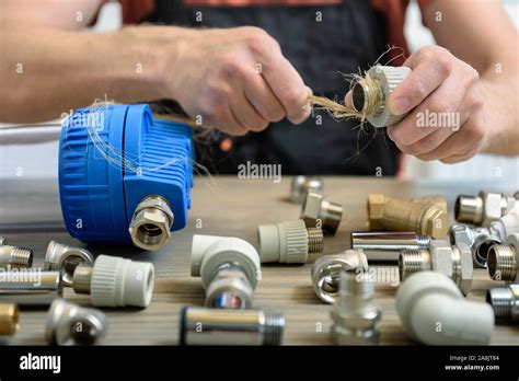 The Worker Is Using A Plumbers Hemp Fibers For Sealing Up Pipe Joints