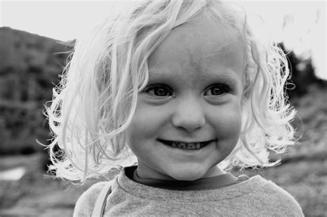 Premium Photo Cute Smiling Girl Looking Away On Field