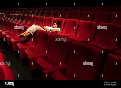 Woman Lying Down On Cinema Seats In Switzerland Local Caption Woman One Woman Only