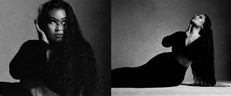 A Woman With Long Black Hair And Glasses Laying On The Floor In Front