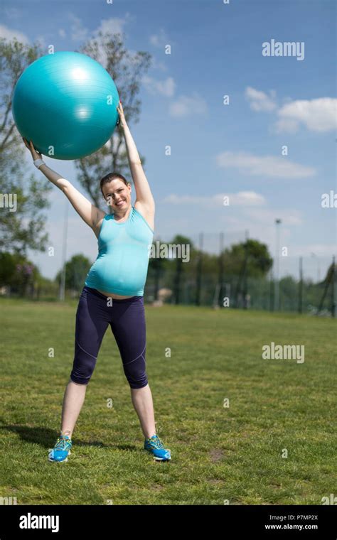 Beautiful Young Pregnant Woman Exercises With Fitball In The Gym Stock
