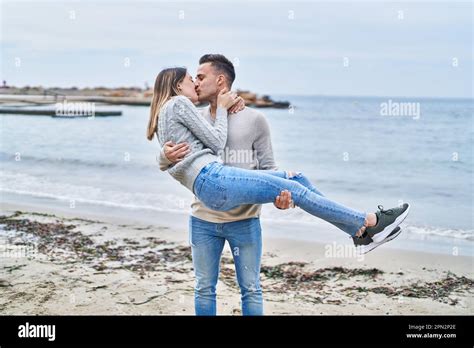 Man And Woman Couple Hugging Each Other Holding On Arms Kissing At