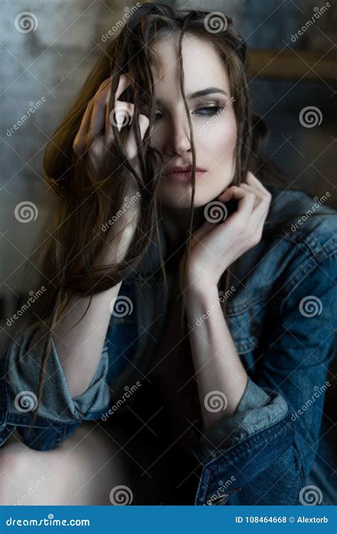 The Beautiful Girl Topless Wearing A Jeans Jacket Touches Her Li Stock