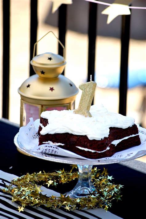 A Piece Of Cake Sitting On Top Of A Table Next To A Candle And Some Decorations
