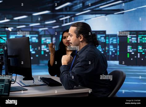 Technicians Reconfiguring Server Room Facility To Optimize It For Data Processing Requirements