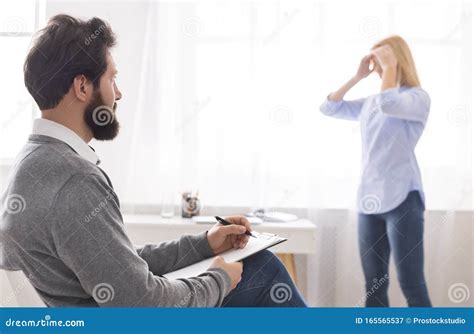 Psychotherapist Listening To Desperate Woman During Therapy Stock Image