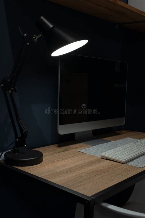 The Computer Desk Is Illuminated By A Desk Lamp In A Dark Room Stock Photo Image Of Creative