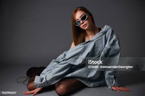 선글라스와 데님 옷을 입은 미래형 여성이 회색 배경에 누워 있다 20 29세에 대한 스톡 사진 및 기타 이미지 20 29세 가냘픈 관능 Istock