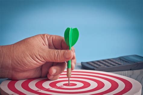 Premium Photo Dart Arrow In Hand On Target Dartboard