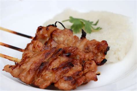 Three Grilled Pork Skewers With Sticky Rice On The White Plate Stock