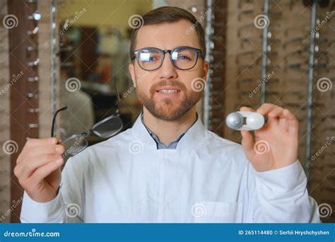 Eye Doctor Choosing Between Eyeglasses And Lenses Standing In The