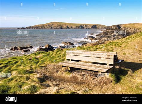 Wooden Bench For Walkers On The Wales National Coastal Path At Gwbert