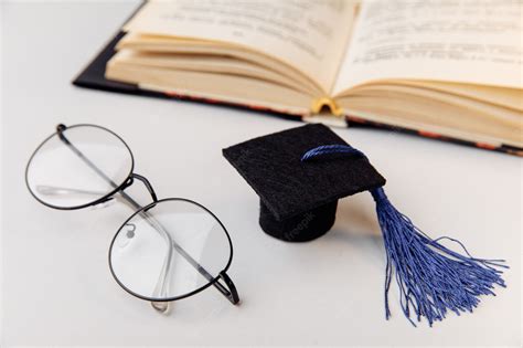 Premium Photo Graduation Cap And Glasses With Open Book Close Up