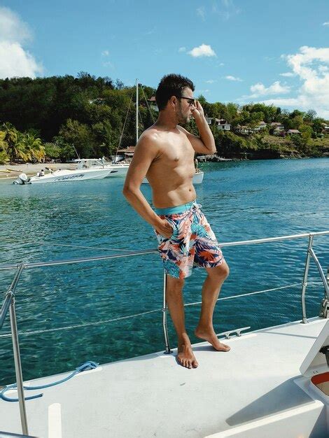 Premium Photo Full Length Of Shirtless Man Standing On Boat