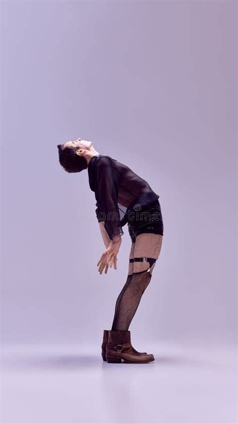 Serene Performer Arching Back In Black Stylish Outfit Head Lifted In