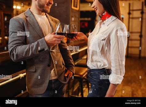 Man And Woman Drinks Red Wine At Wooden Bar Counter Couple Leisures In