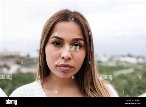 Young Hispanic Girl Looking At Camera Outdoor Focus On Face Stock