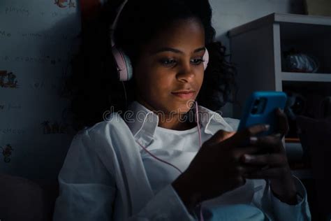 African Teen Girl Sitting On A Bed With Phone Stock Image Image Of Read Mobile 260828281