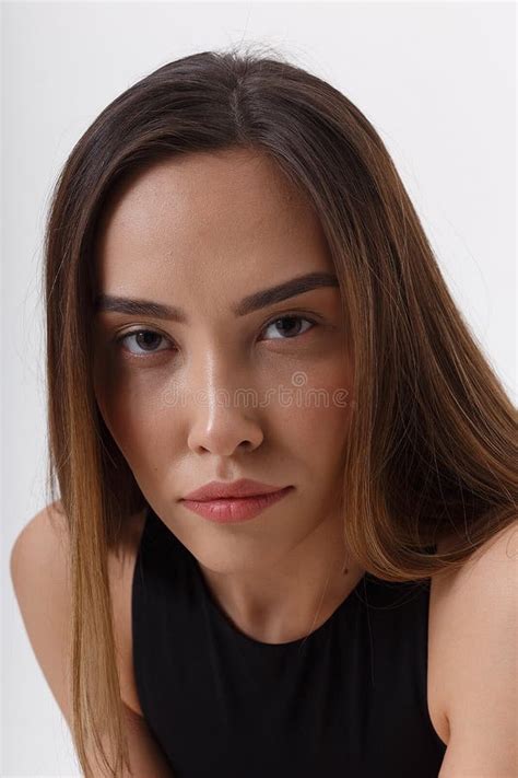 Portrait Of Young Attractive Asian Woman With Long Dark Hair In Black
