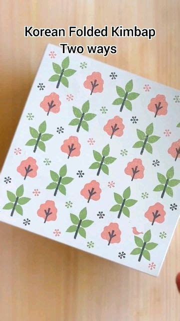Someone Holding Up A Box With Flowers On It And The Words Korean Folded