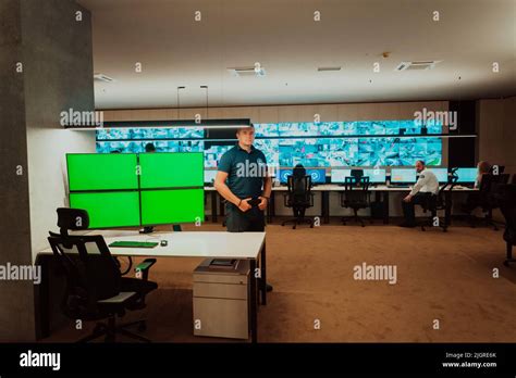 male security operator working in a data system control room offices
