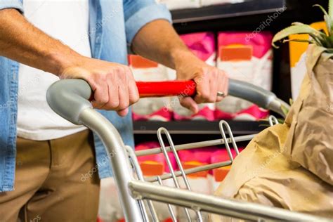 Man Pushing Trolley Stock Photo Wavebreakmedia