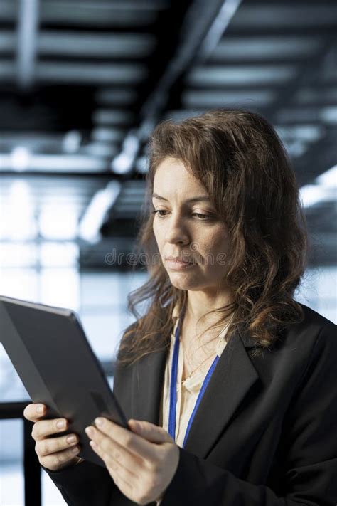 Woman In Data Center Operating Tablet Analyzing Metrics Stock Image