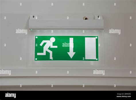 Emergency Exit Sign Glowing In The Dark Stock Photo Alamy