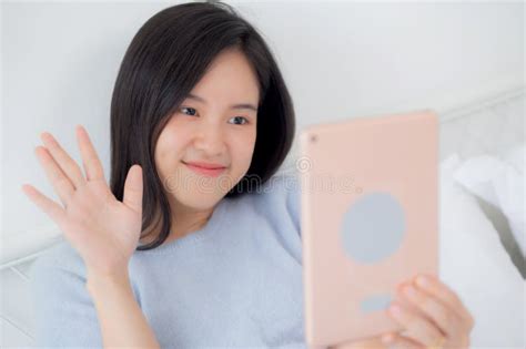 Happiness Young Asian Woman Sitting On Bed Video Call With Digital