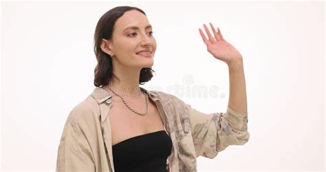 Smiling Brunette Woman Waves Hand Radiating Positive Energy Stock Video