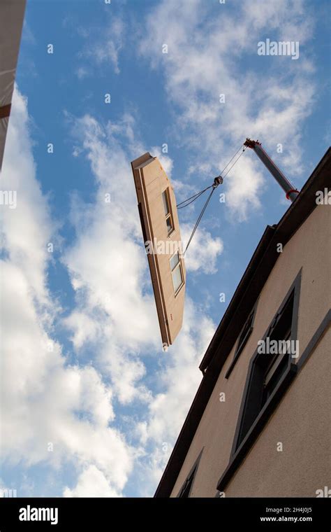 The Sloping Component For A Prefabricated House Hovers On The Crane