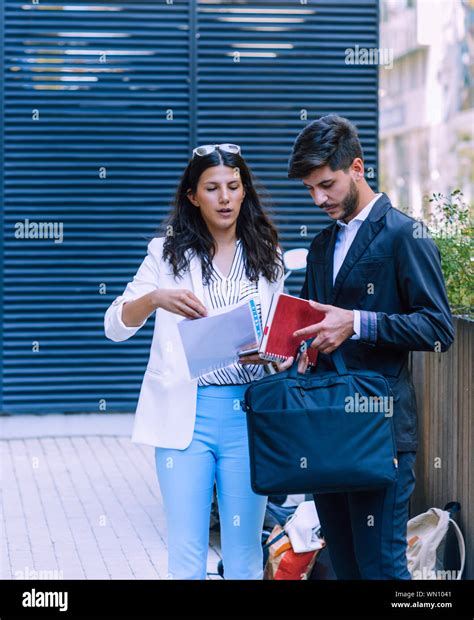 Business Man And Business Woman Standing Together And Analyse Documents