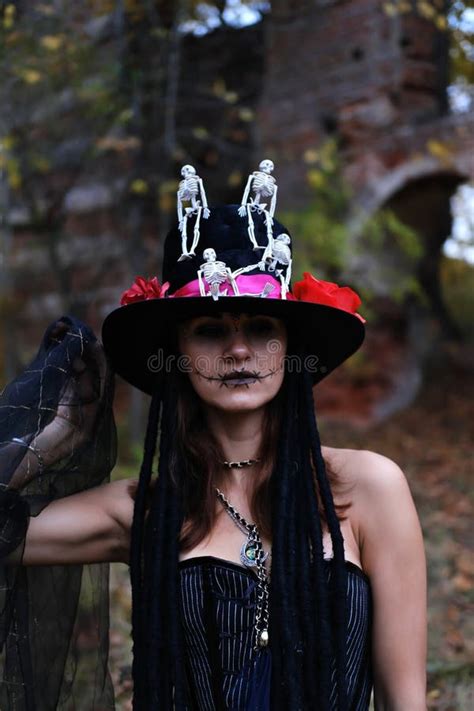 Female Look For Halloween Make Up Woman In A Black Corset And Top Hat