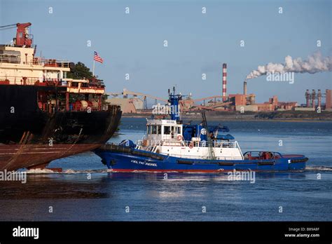 Tugboat Pushing Cargo Ship In Foynes Harbour County Limerick Ireland