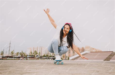 Premium Photo A Beautiful Young Girl With Dreadlocks Rides A