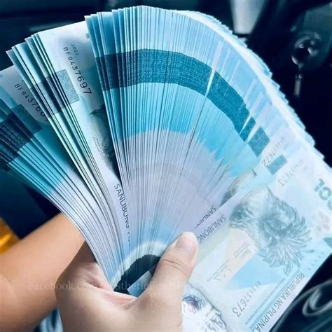 A Person Holding Up Several Bills In Their Hand
