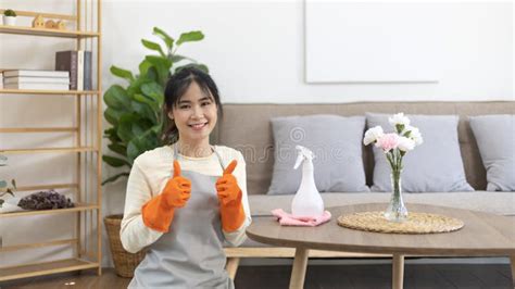 Beautiful Asian Housewife Wearing Apron And Cleaning Gloves Prepares To
