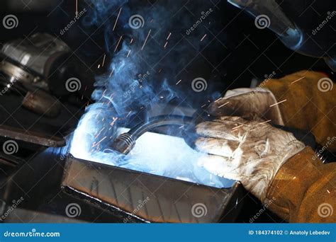 A Highly Skilled Welder Welds A Metal Structure At An Assembly Plant
