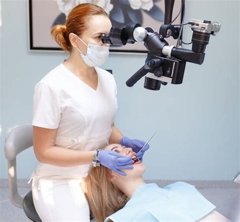 Premium Photo Female Dentist With Dental Tools Microscope Mirror