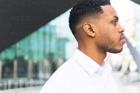 Thoughtful Side View Of African American Male Entrepreneur In Elegant Suit Looking Away While