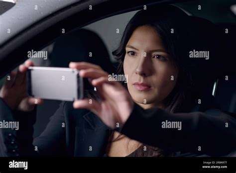 Attractive Serious Woman Taking A Selfie On Her Mobile Phone As She
