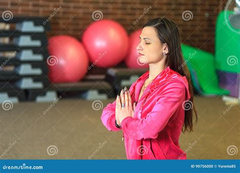 Yoga Training Beautiful White Girl In A Pink Sports Suit Meditates On