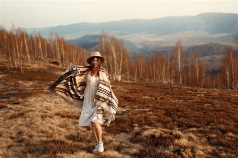 Premium Photo Beautiful Boho Woman Hipster Having Fun Wearing Hat And Poncho At Sunset In