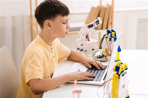 Boy Creating Robotics Project On Laptop In Class Stock Image Image Of