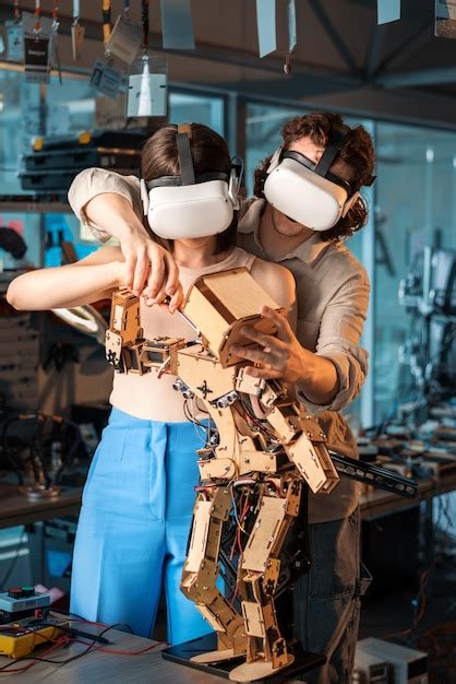 Premium Photo Young Man And Woman In Protective Glasses Doing Experiments In Robotics In A