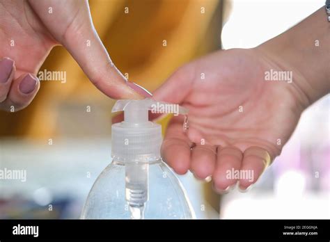 Woman Sanitizing Hands With Alcohol Gel Hand Sanitizer Disinfectant