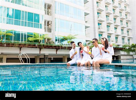 Asia Friends Having Fun By Swimming Pool Stock Photo Alamy