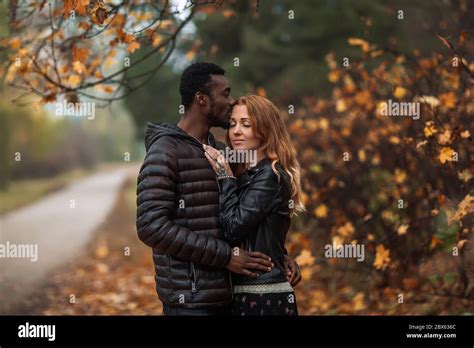 Happy Cute Interracial Couple Posing In Blurry Autumn Park Background