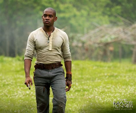 A Man Standing In The Middle Of A Field With His Hand On His Hip And Looking At The Camera